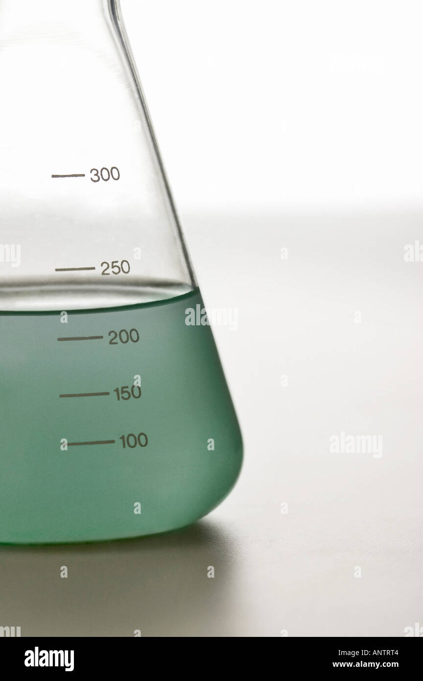 CHEMISTRY MEASURING BEAKER WITH GREEN LIQUID INSIDE, CLOSE UP, PART OF ...