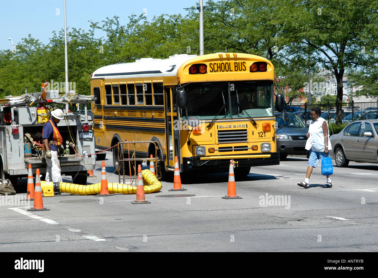 An underground Utility Cable repairman is surrounded by safety barriers ...