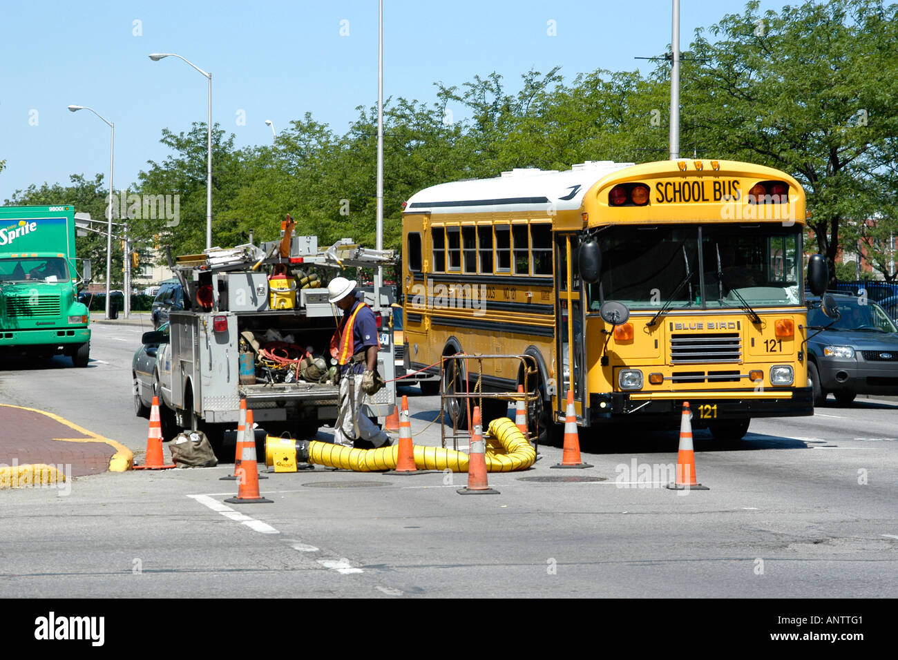 An underground Utility Cable repairman is surrounded by safety barriers ...