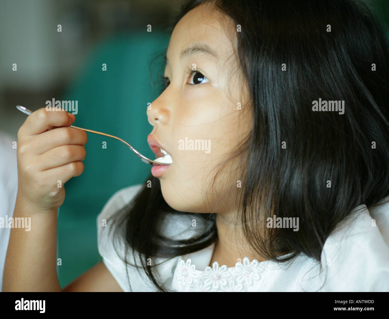 Side profile of a girl eating a cake Stock Photo - Alamy