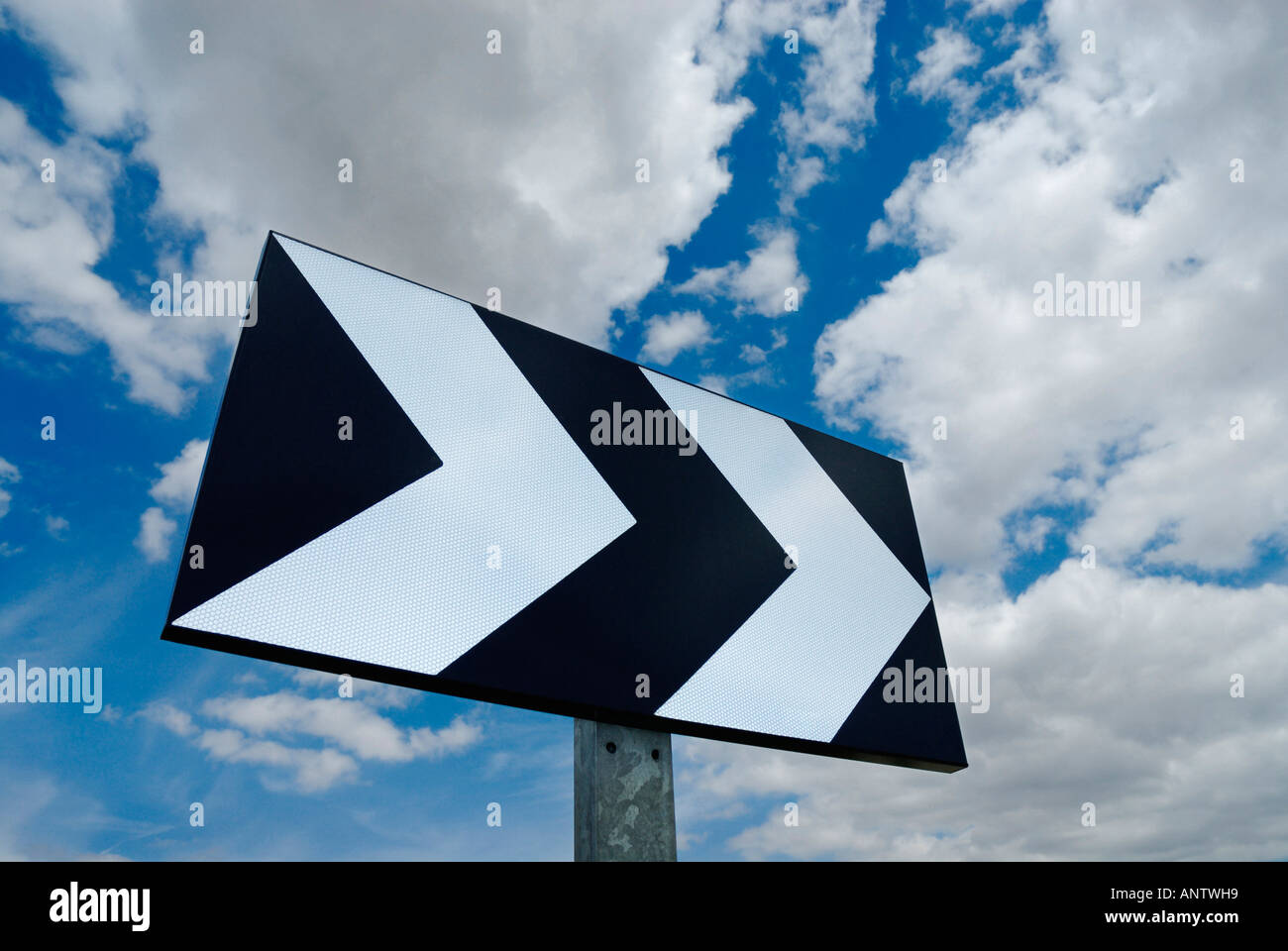 TRAFFIC SIGN POST INDICATING CURVE AND DIRECTION BOARD ON BLUE SKY ...