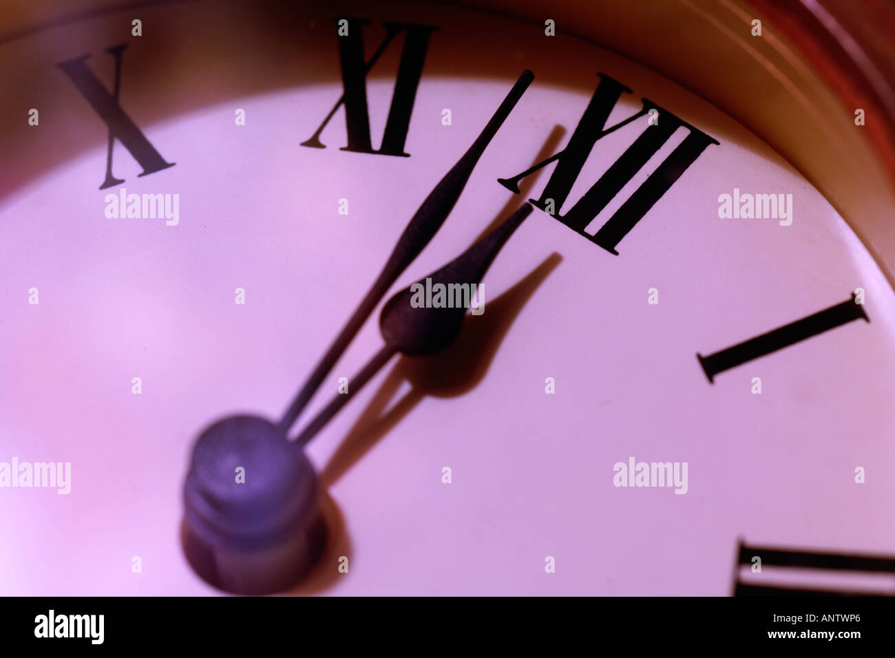 Close up of old fashioned clock face with hands at nearly twelve o ...