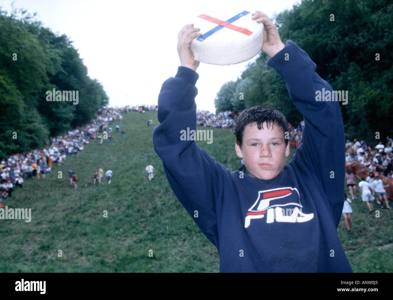 BOY HOLDING CHEESE AFTER RUNNING DOWN HILL CHEESE ROLLING RACE WINNER ...
