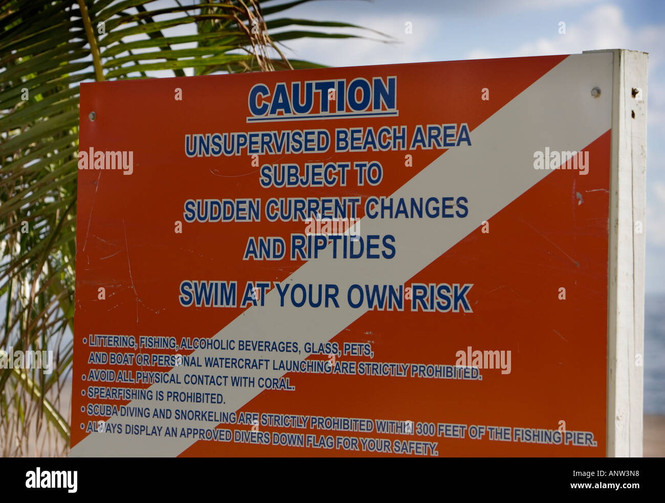 Sign warning risk of riptides on the beach Stock Photo - Alamy