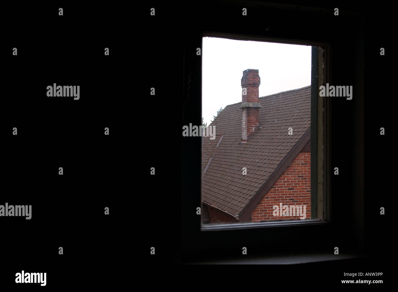 View through a window of a brick house with a chimney in Tacoma, WA ...