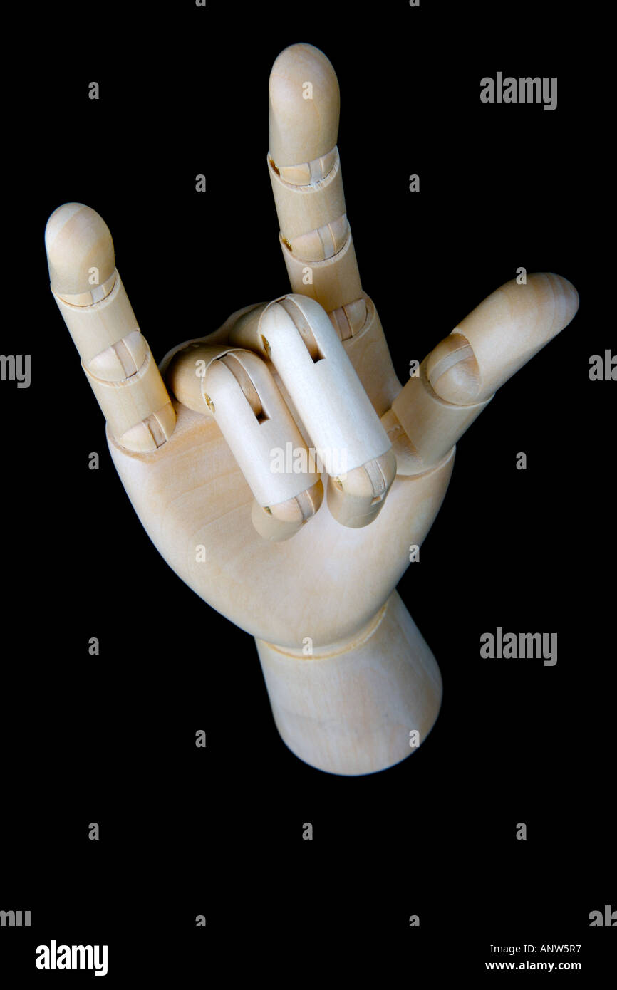 A wooden artists modelling hand showing the surfing gesture for shaka ...