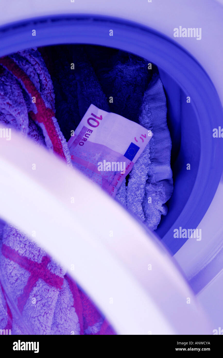 Washing machine with laundry and money Stock Photo - Alamy