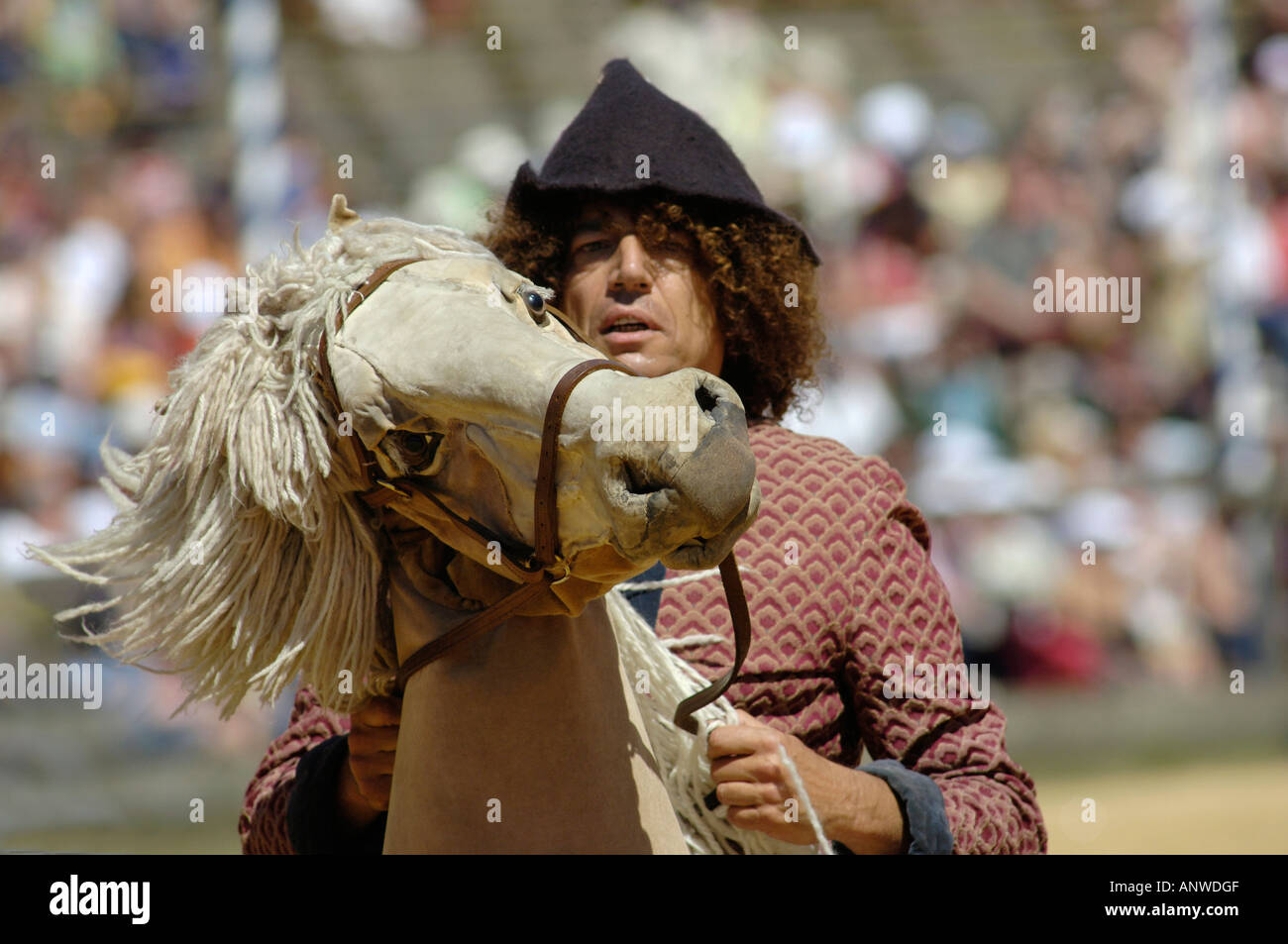 Man with mediaeval medieval costume rides on a horse dummy, knight ...