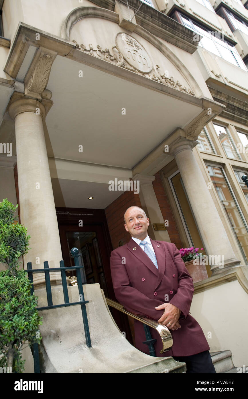 A Concierge stands outside a London Hotel Stock Photo - Alamy