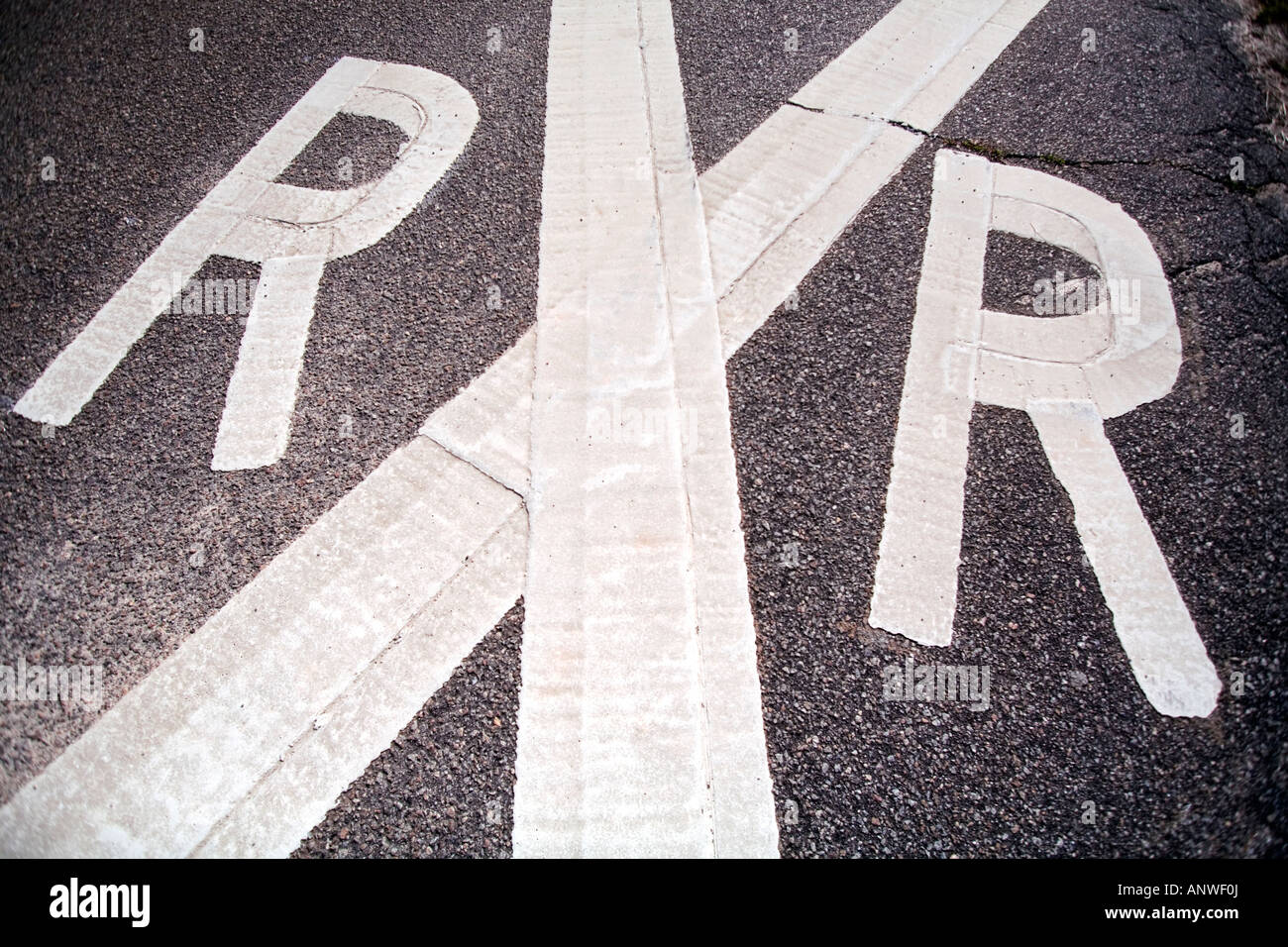 Railroad crossing warning sign painted on road Stock Photo - Alamy