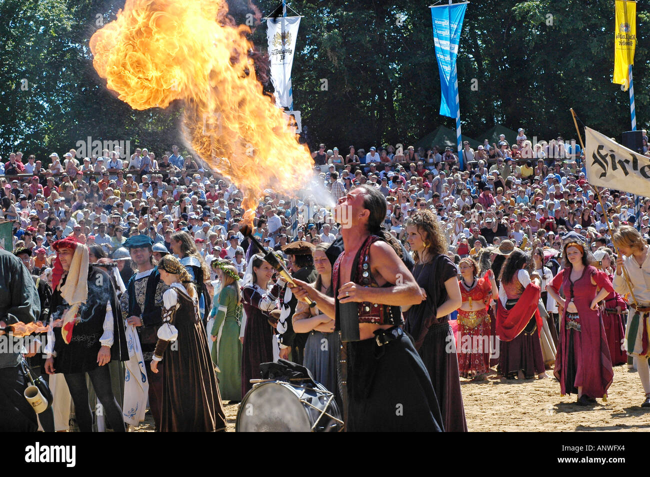 Fire-eater at move of the comedians in mediaeval medieval costume in ...