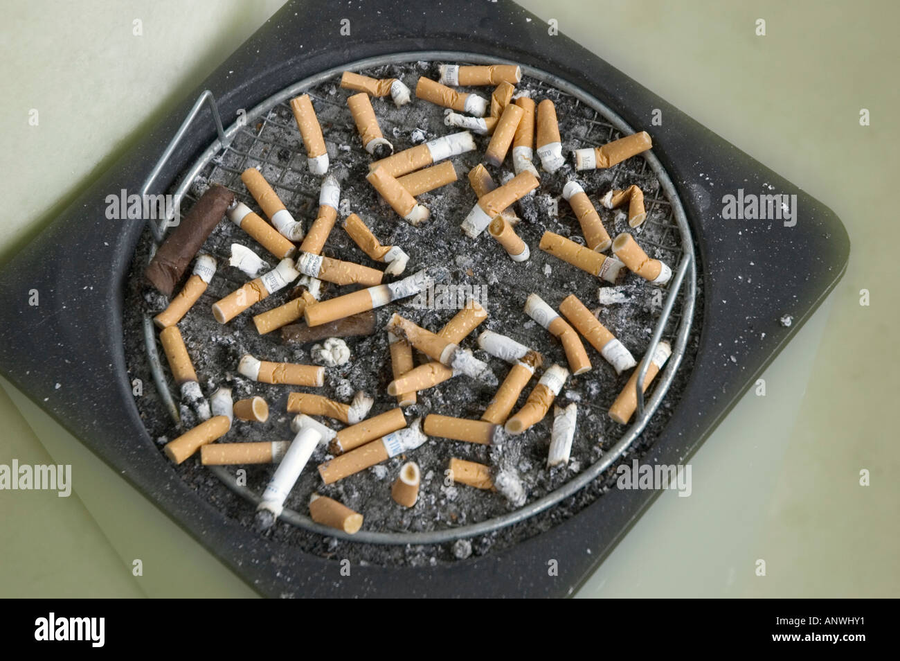 Ashtray ash-tray with many butts Stock Photo - Alamy