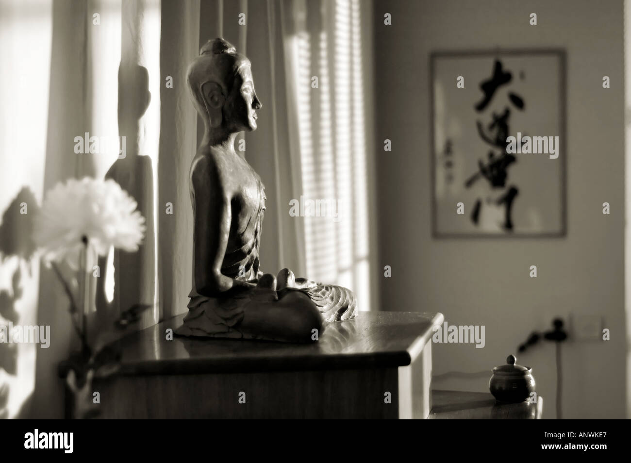 Clay buddha statue on wooden altar in a zen center in Brno Czech ...