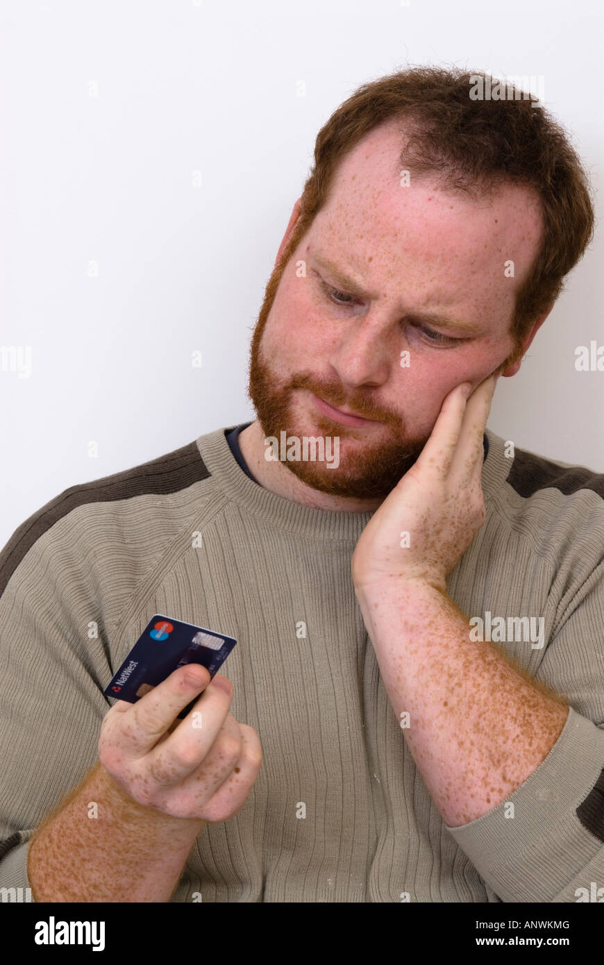 man thinking about credit debit bank card Stock Photo - Alamy