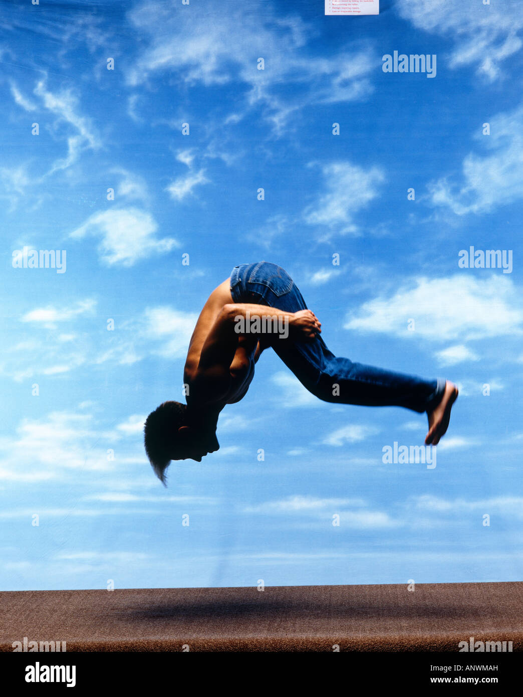 Guy doing a somersault against sky background Stock Photo - Alamy