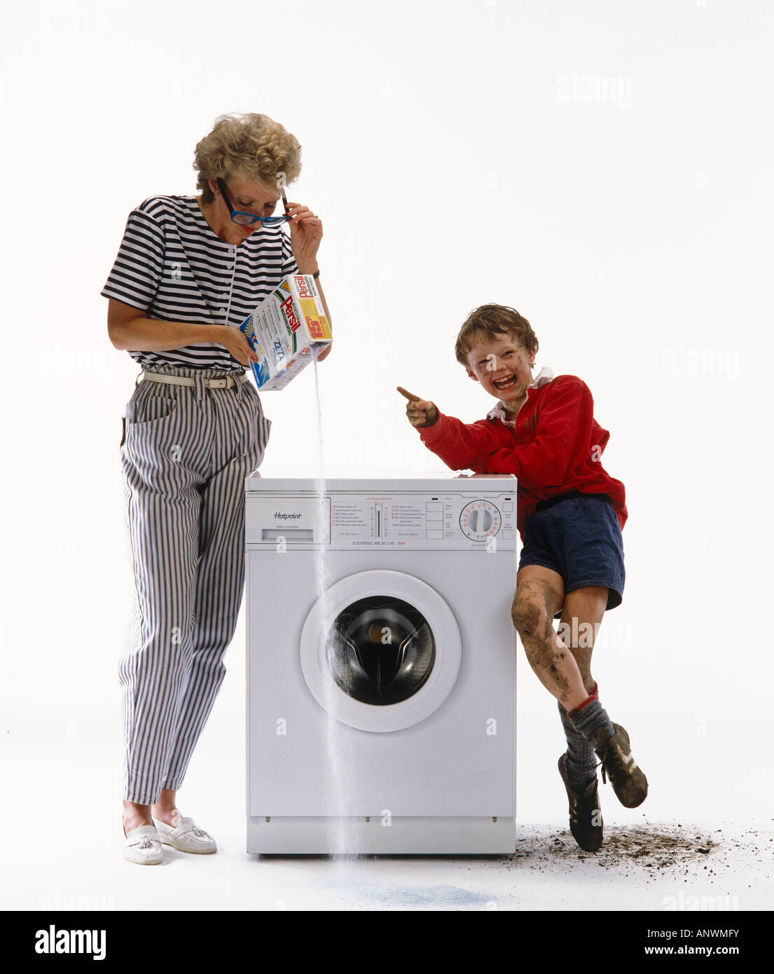 Washing Machine with mother (reading instructions on soap powder) and ...