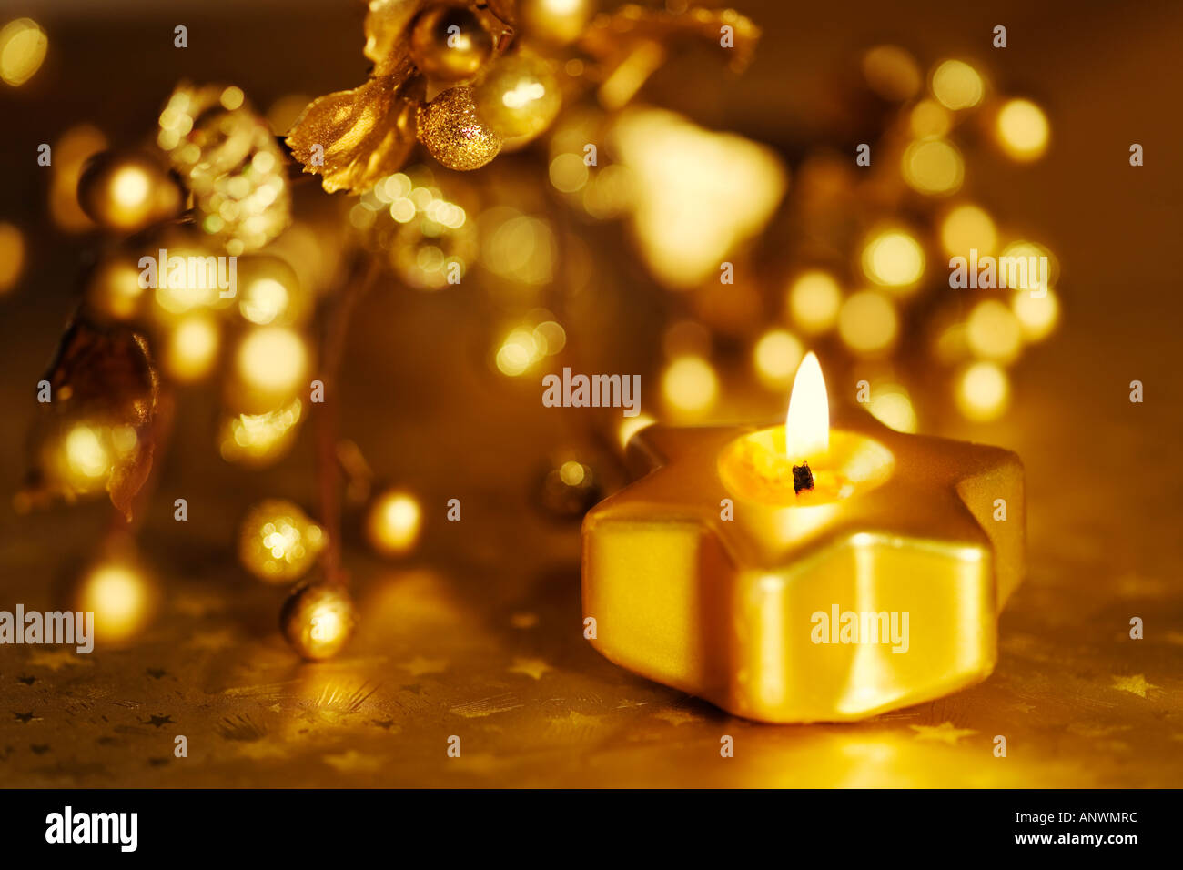 Golden burning candle Stock Photo - Alamy