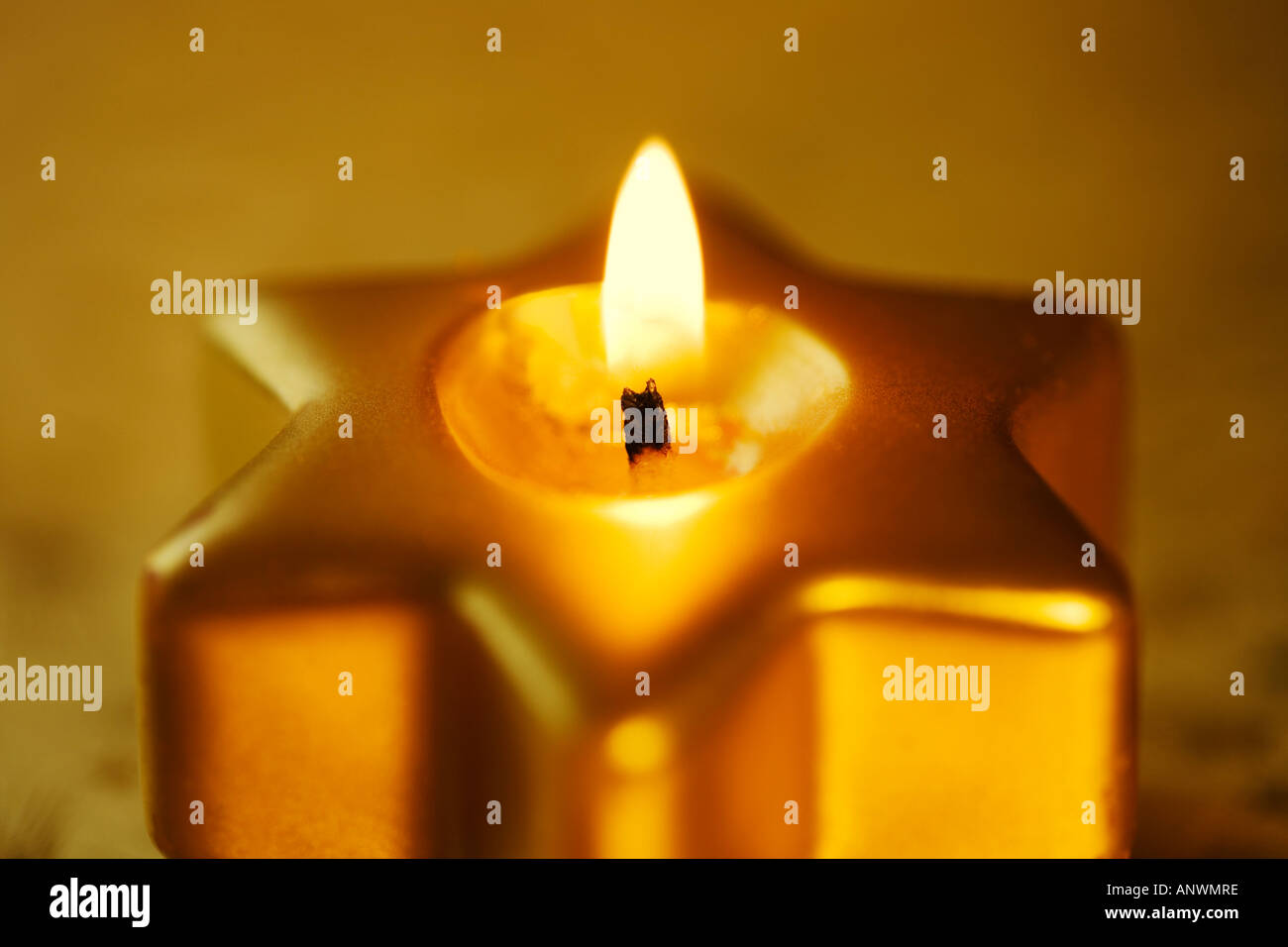 Golden burning candle Stock Photo - Alamy