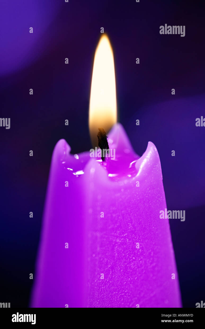 Burning violet candle Stock Photo - Alamy