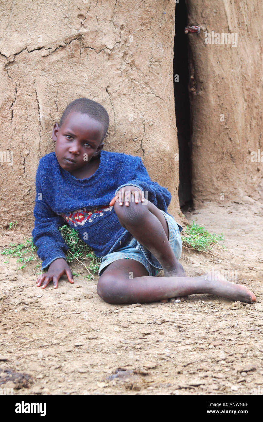 Maasai boy outside mud hut made of sticks and cow dung Masai Mara ...
