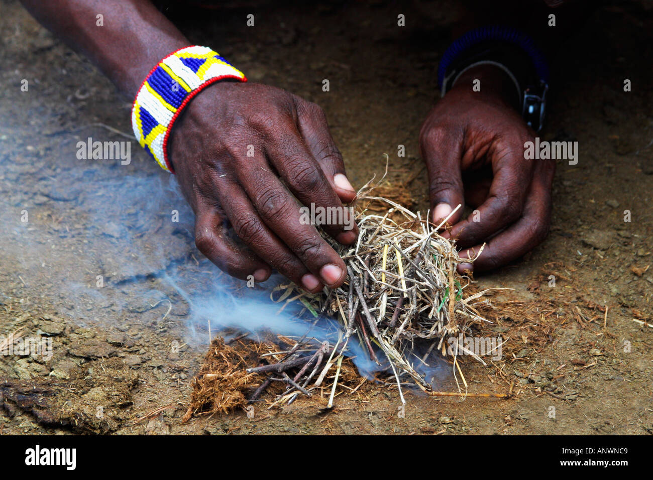 Maasai warrior making fire Masai Mara National Nature Reserve Kenya ...