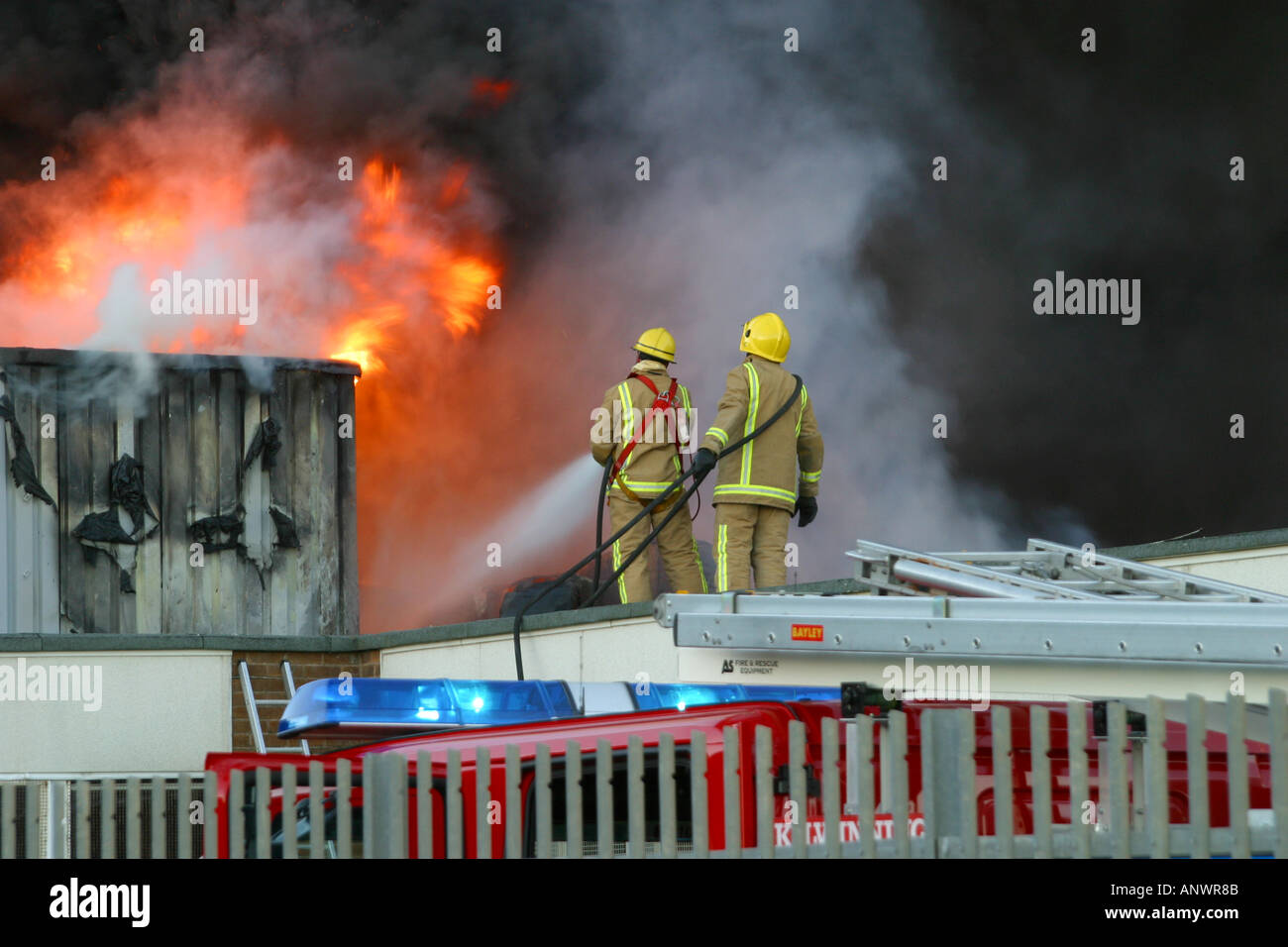 Firemen in action at school fire Stock Photo - Alamy