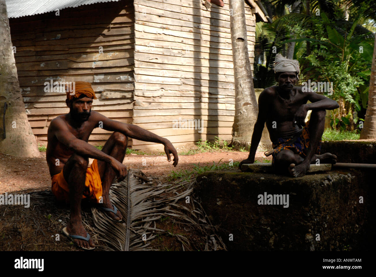 2 men chilling by the backwaters of kerala Stock Photo - Alamy