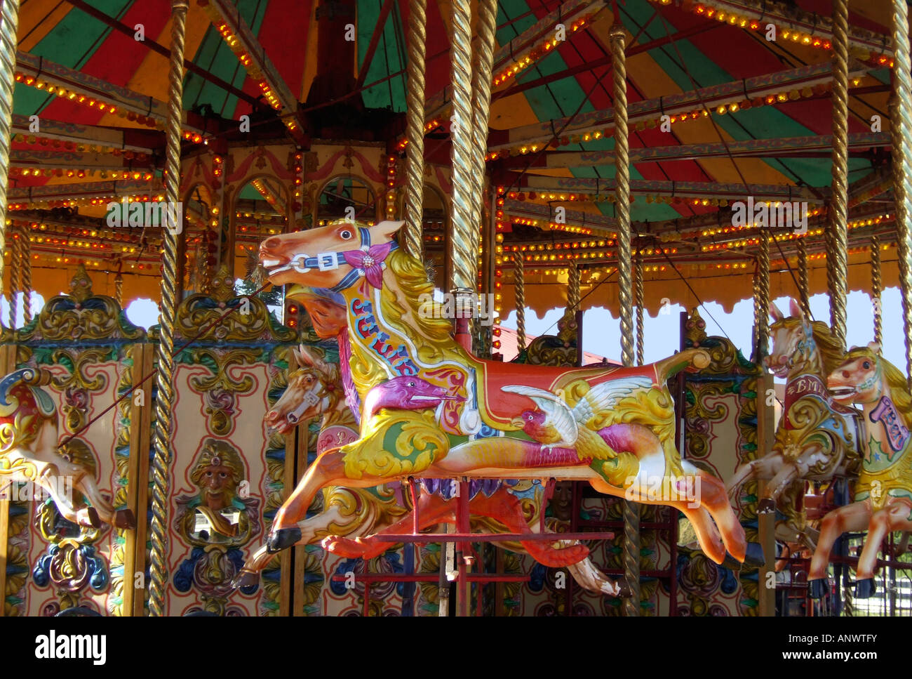 BHZ Brightly painted Carousel horses on a playground ride in the ...