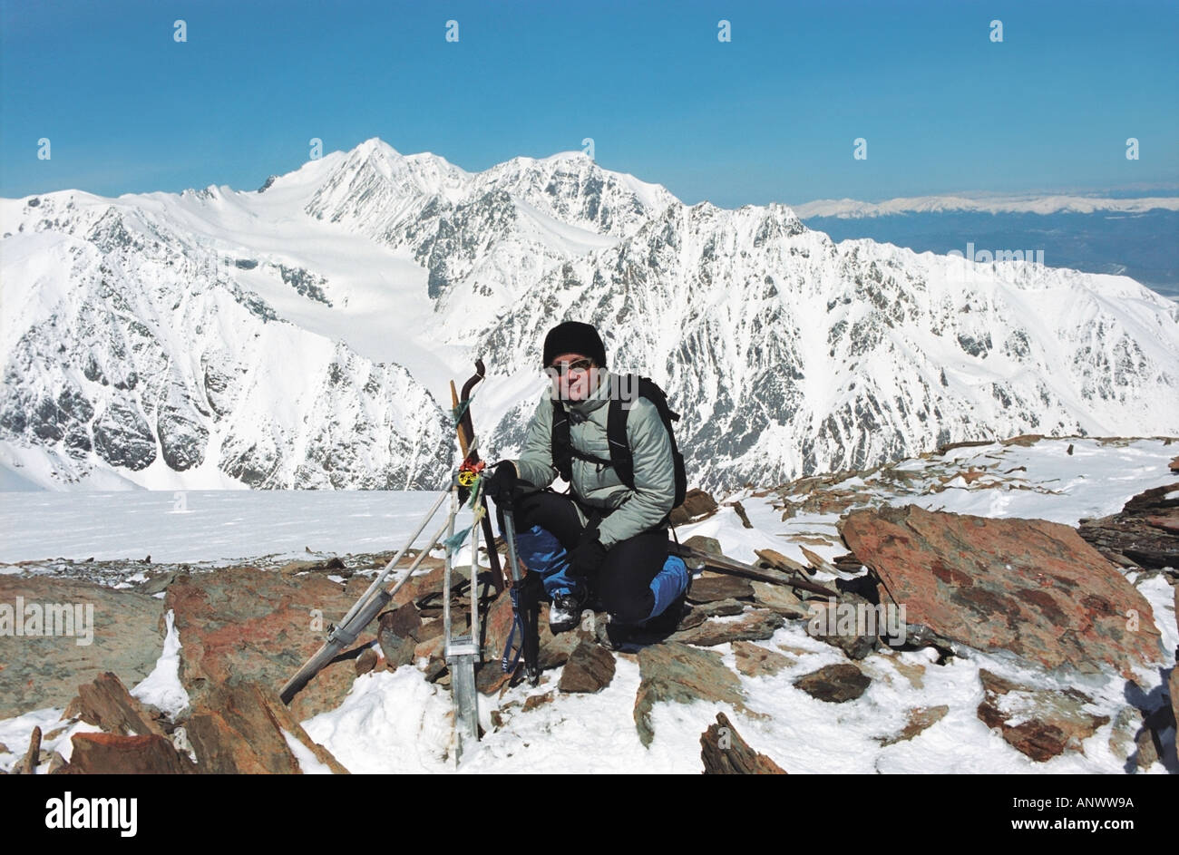 An alpinist sitting on the Kupol Mount s summit The Northern Chuya ...