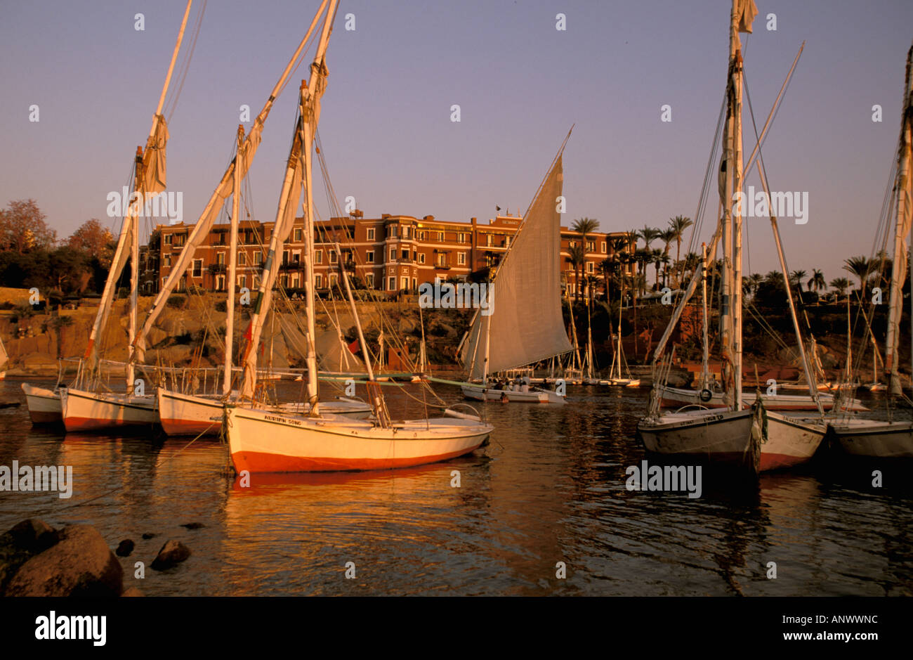 Africa, Egypt, Aswan. Feluccas and Cataract Hotel at sunset viewed from ...