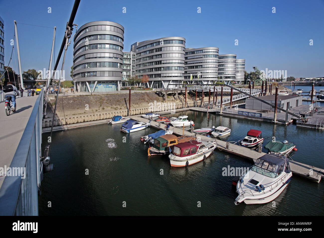 pedestrian bridge with the marina and the five boats in the inner ...