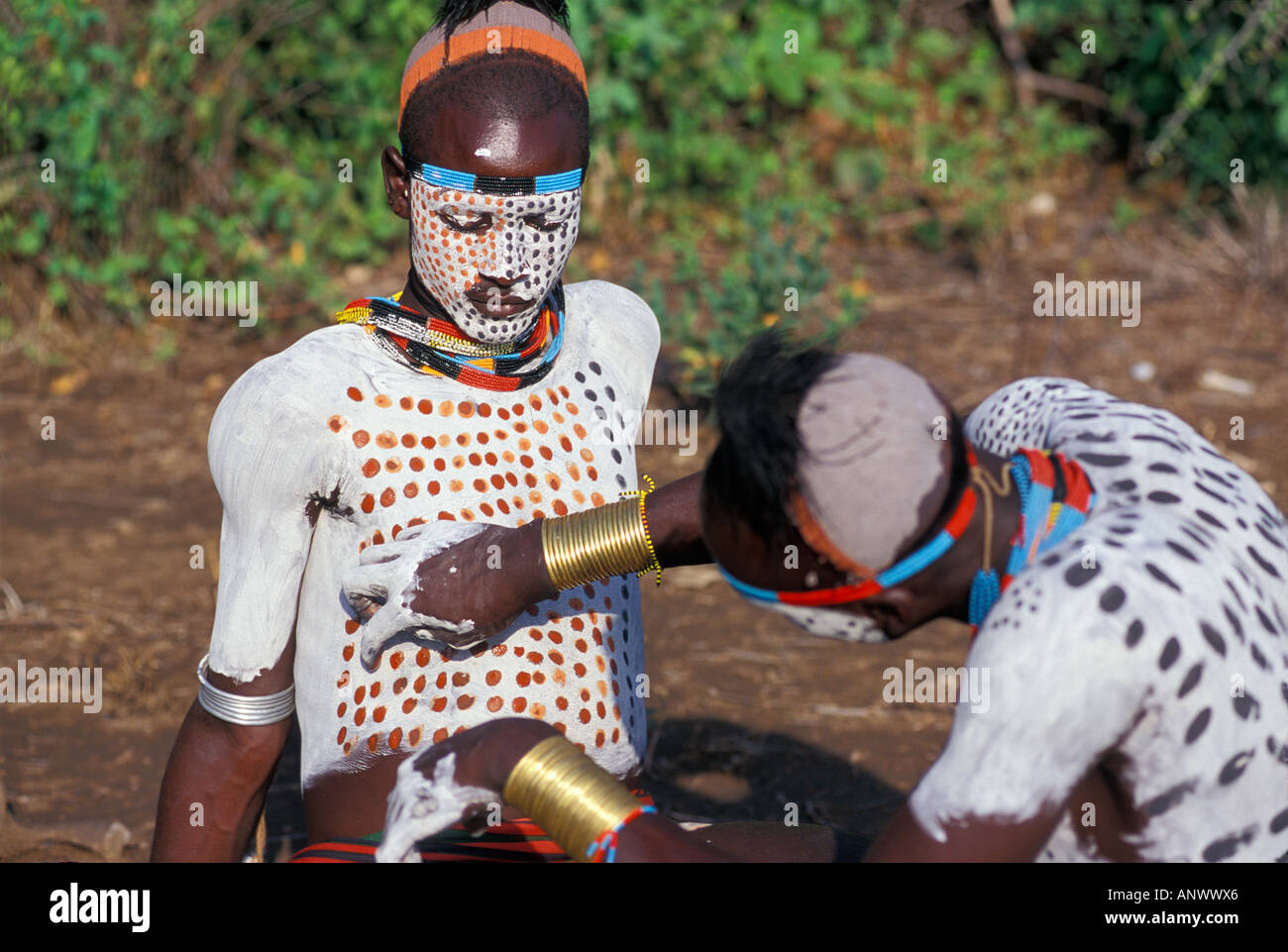 Karo warriors applying body paint near their village in the Omo regoin ...