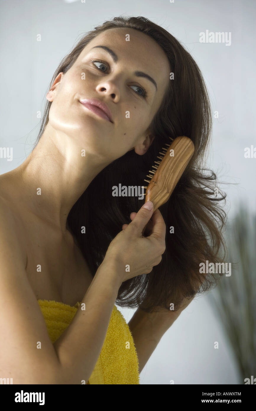 young woman combing her hair Stock Photo - Alamy