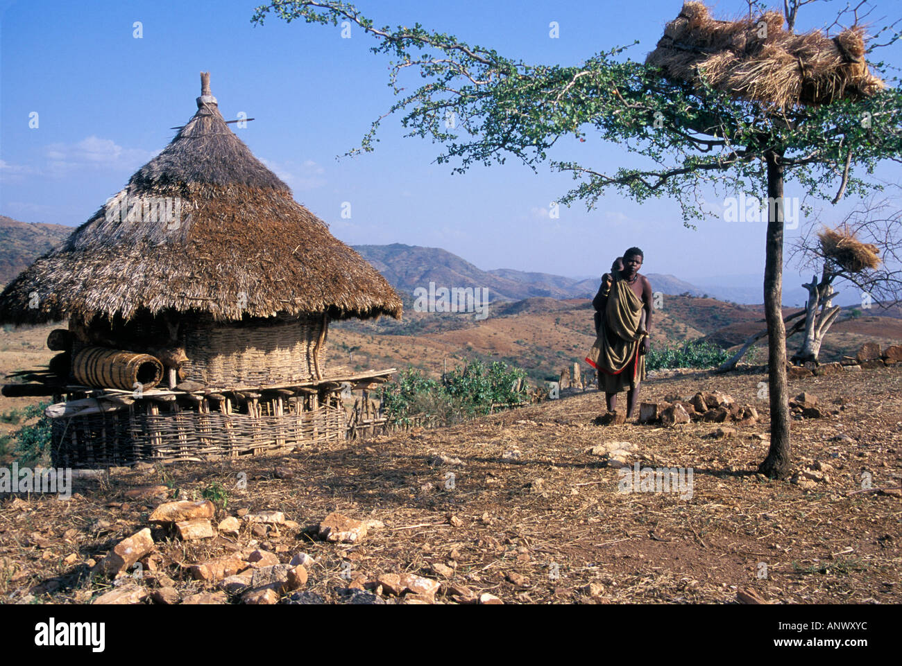 Africa, Ethiopia, Omo river region, Mother and child walk through a ...