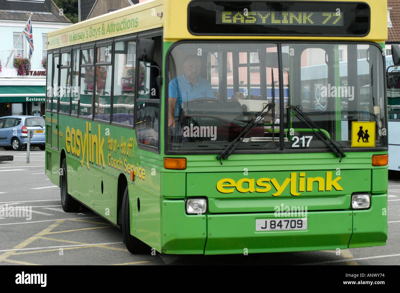 Local green bus picking up passengers at Gorey in Jersey Stock Photo ...