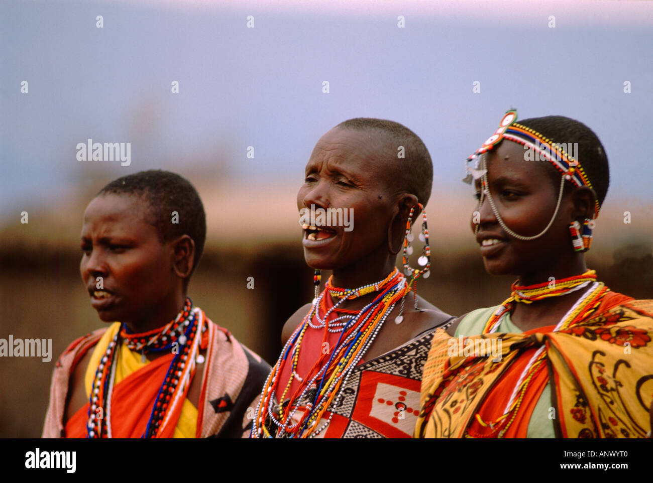 Africa, Kenya, Maasai Mara. Three Maasai woman in traditional attire ...
