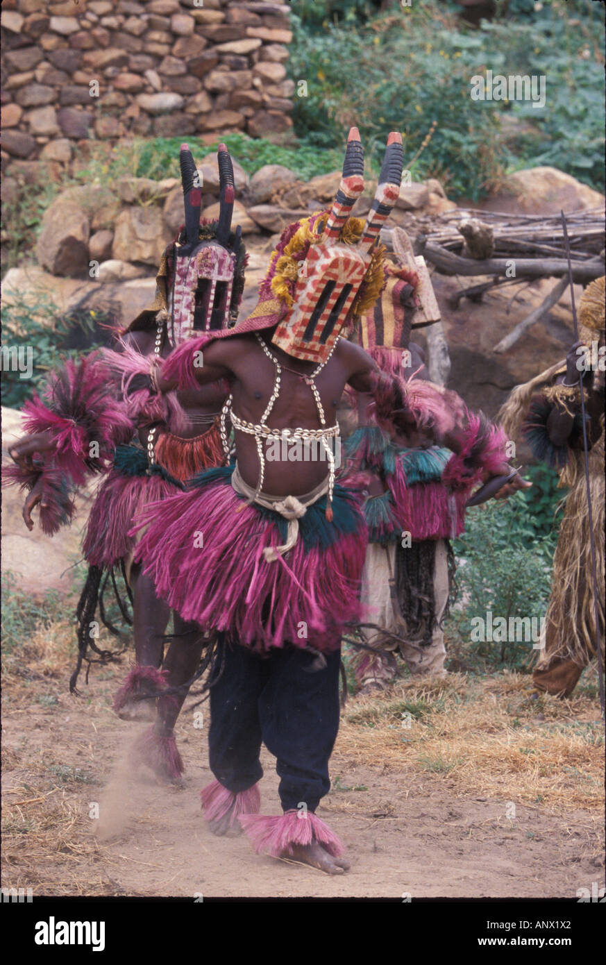 Masked Dogon dancers perform a traditional ceremony, in the village of ...
