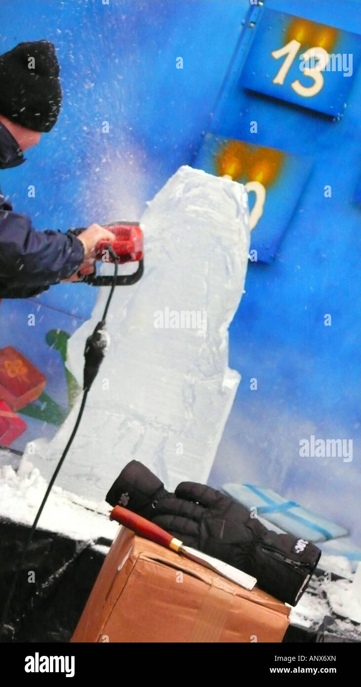 artist modelizing an ice block with a chain saw Stock Photo - Alamy