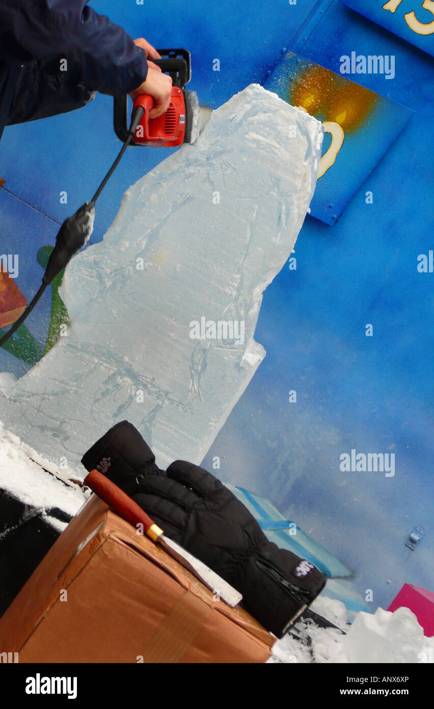 artist modelizing an ice block with a chain saw Stock Photo - Alamy