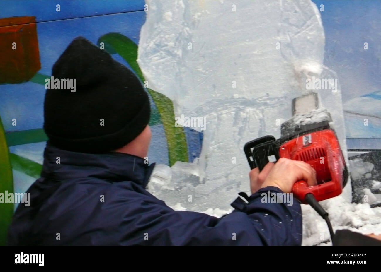 artist modelizing an ice block with a chain saw Stock Photo - Alamy