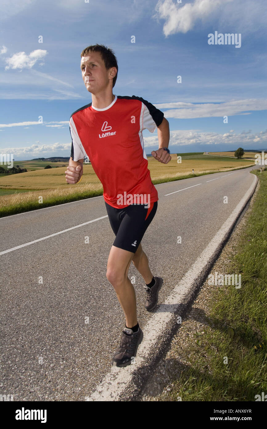 Man running at the roadside hi-res stock photography and images - Alamy