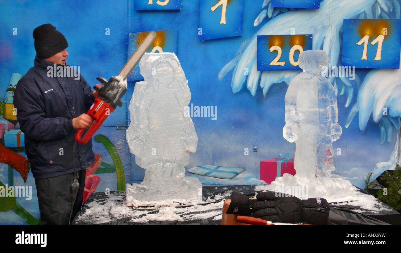 artist modelizing an ice block with a chain saw Stock Photo - Alamy