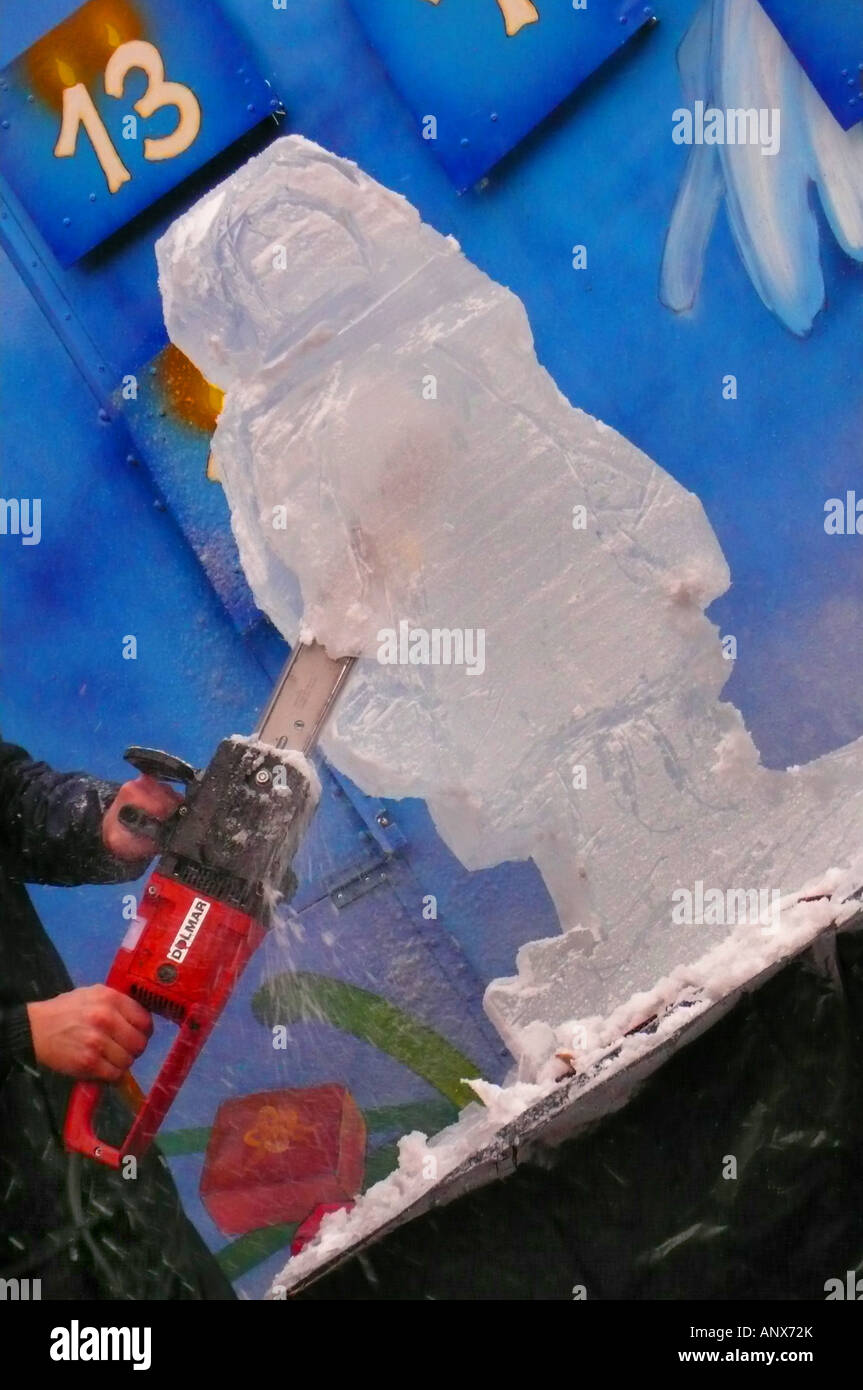 artist modelizing an ice block with a chain saw Stock Photo - Alamy