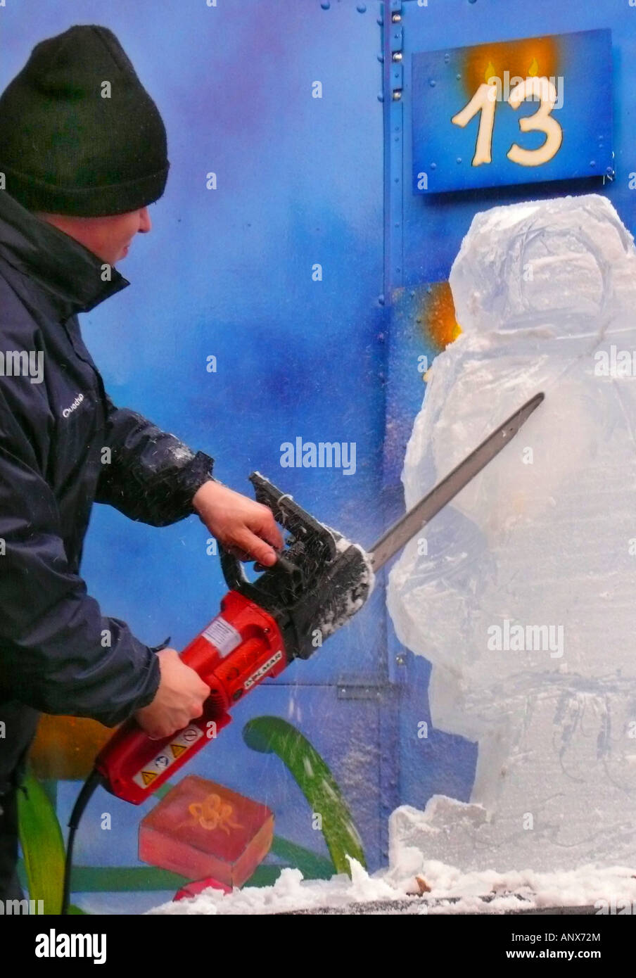 artist modelizing an ice block with a chain saw Stock Photo - Alamy