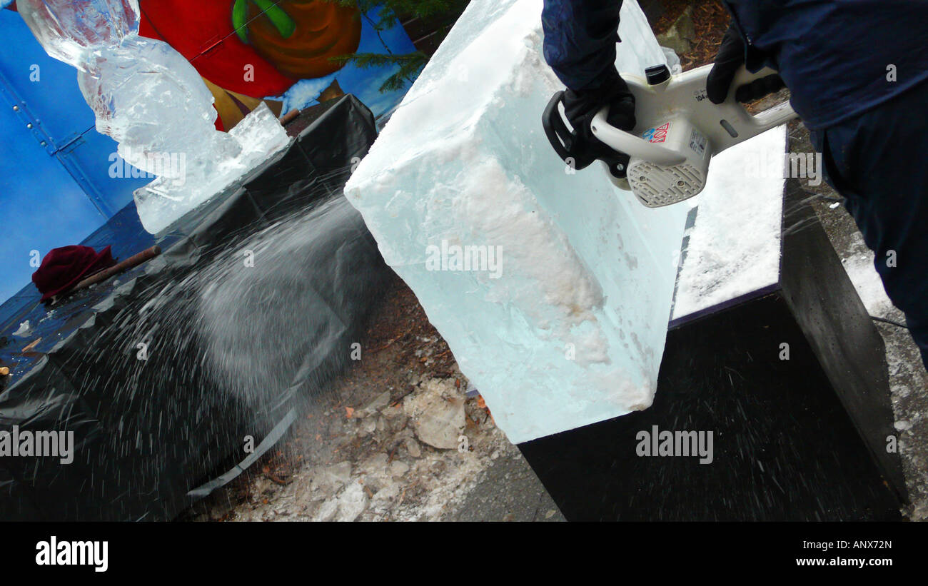 artist modelizing an ice block with a chain saw Stock Photo - Alamy