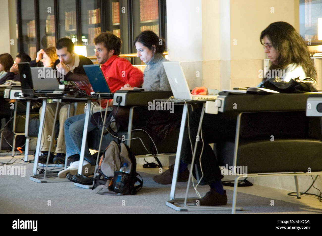 British Library people in line working with notebbok sit in armchair ...