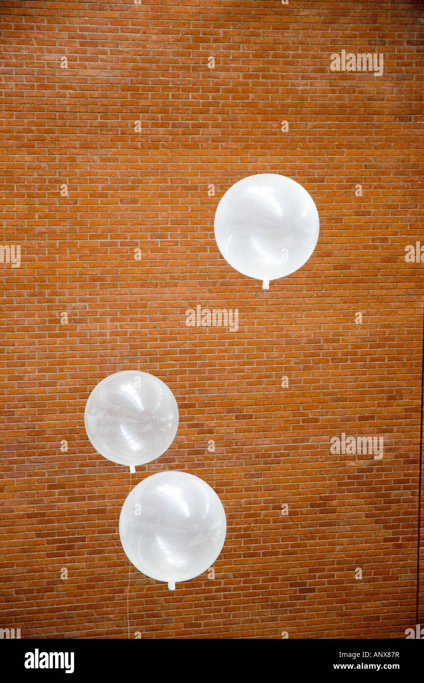 British Library three white balloon in a background of orange bricks ...