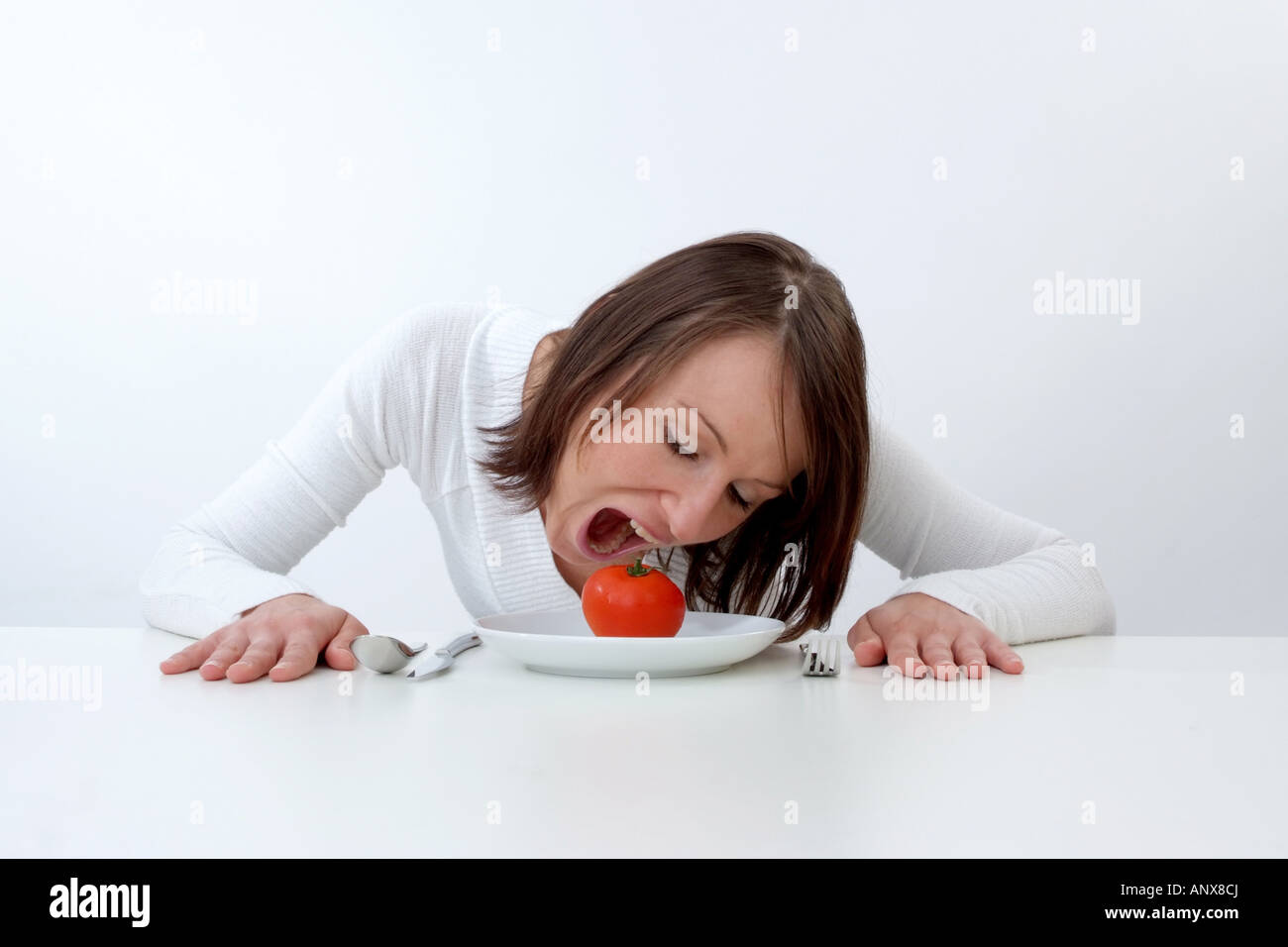 woman eating tomato Stock Photo - Alamy