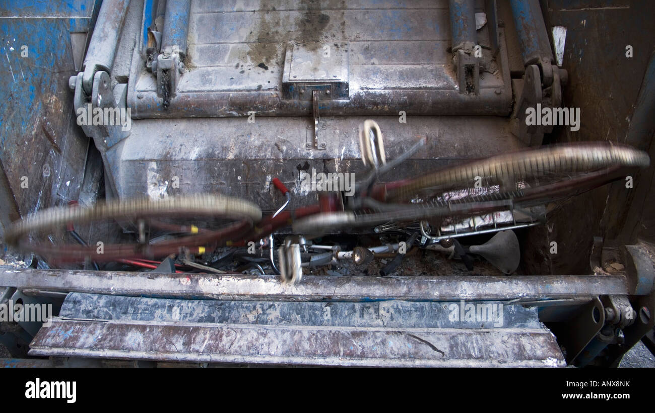 An old bike gets crushed into a garbage truck Stock Photo - Alamy