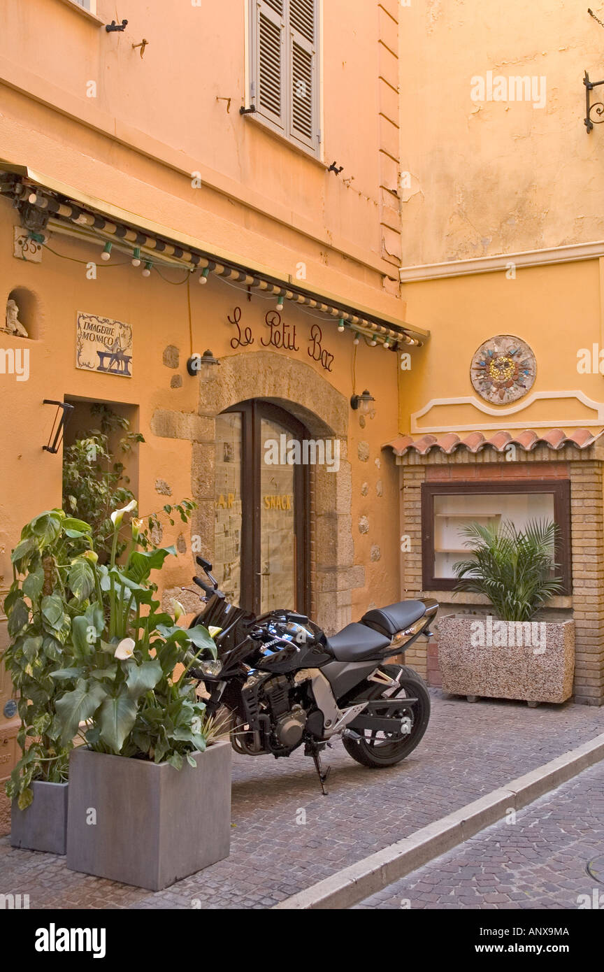 A vertical picture of a coloured building with a Motor Cycle in the Old ...